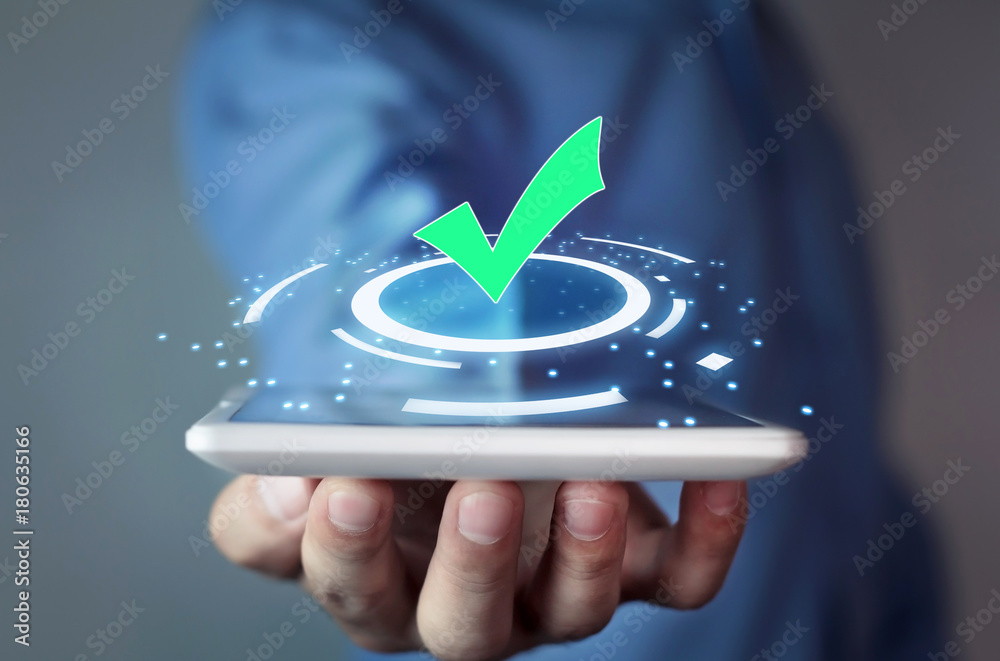 Man holding green check mark symbol. Stock Photo | Adobe Stock