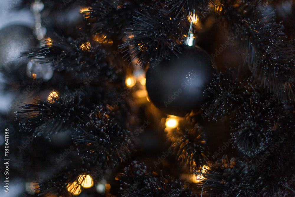 Christmas dark blurred background with a black Christmas tree ...