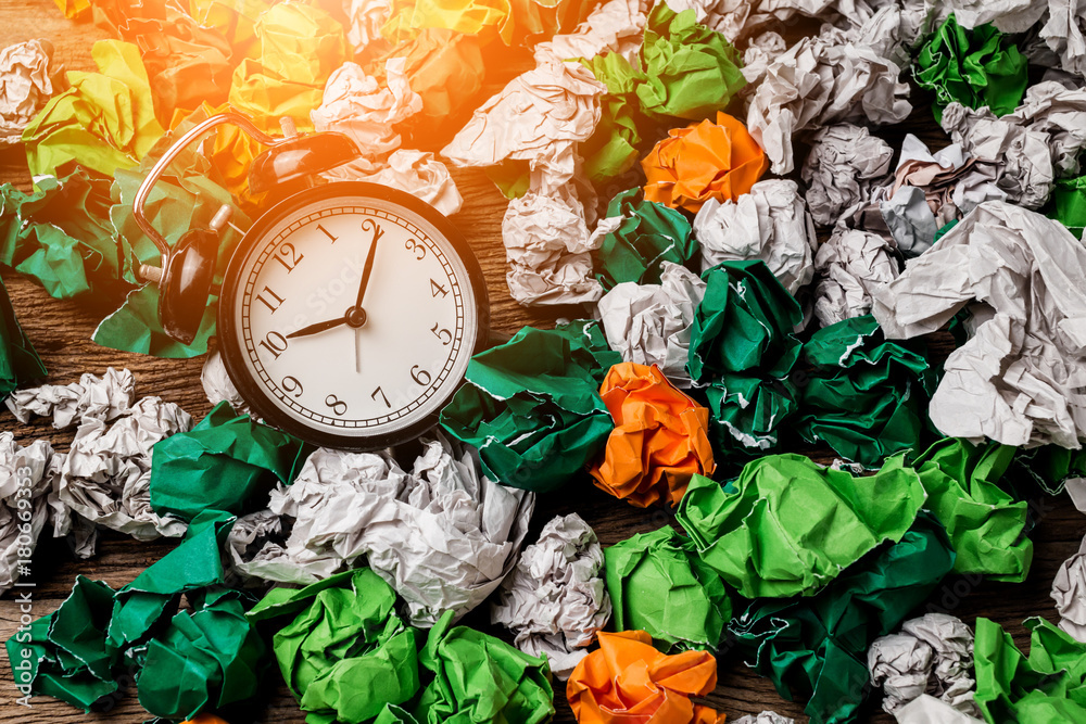 Alarm clock in a wastepaper concept for a time waste of time with cork ...