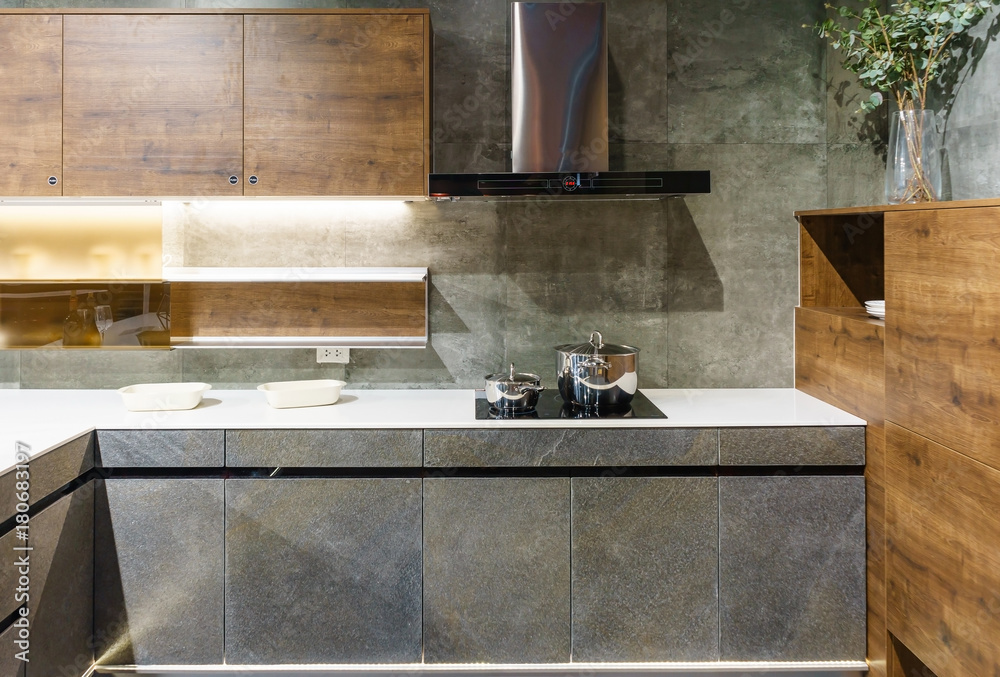 Modern kitchen furniture with contemporary kitchenware like hood, black ...