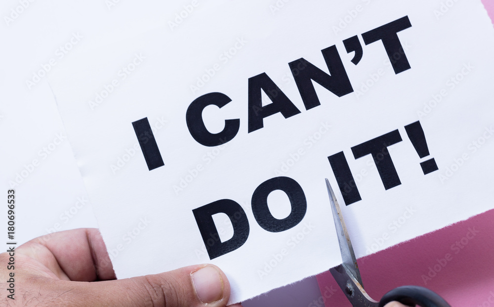 Man cutting with scissors the piece of paper with words I can't do it ...