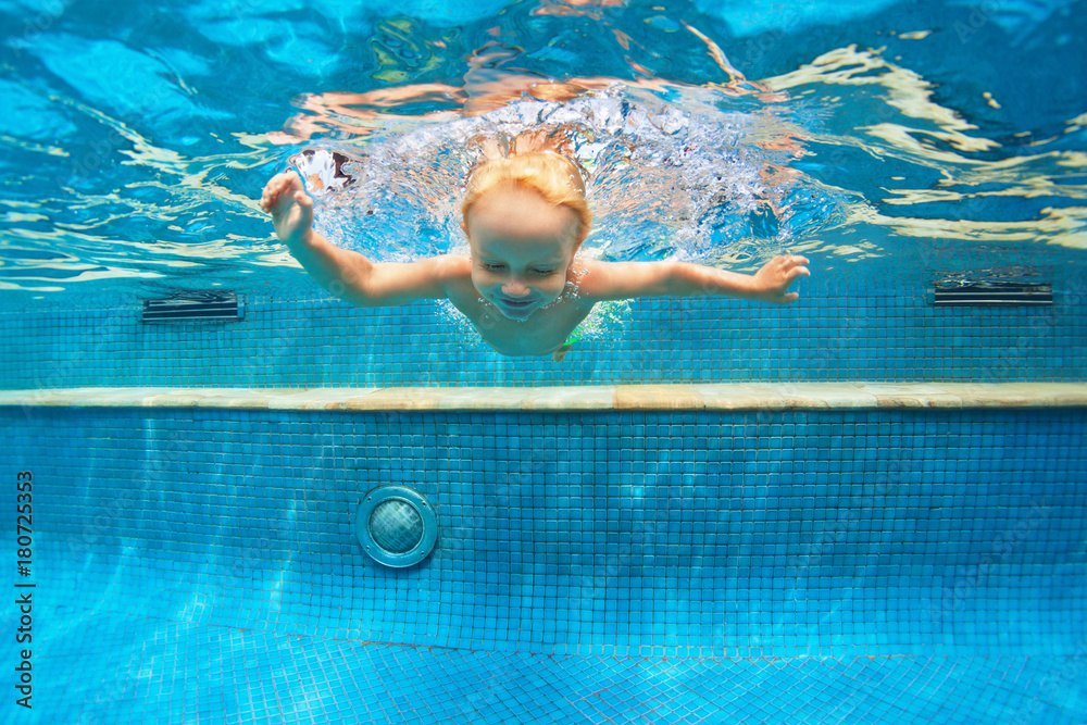 Funny portrait of child learn swimming, diving in blue pool with fun ...