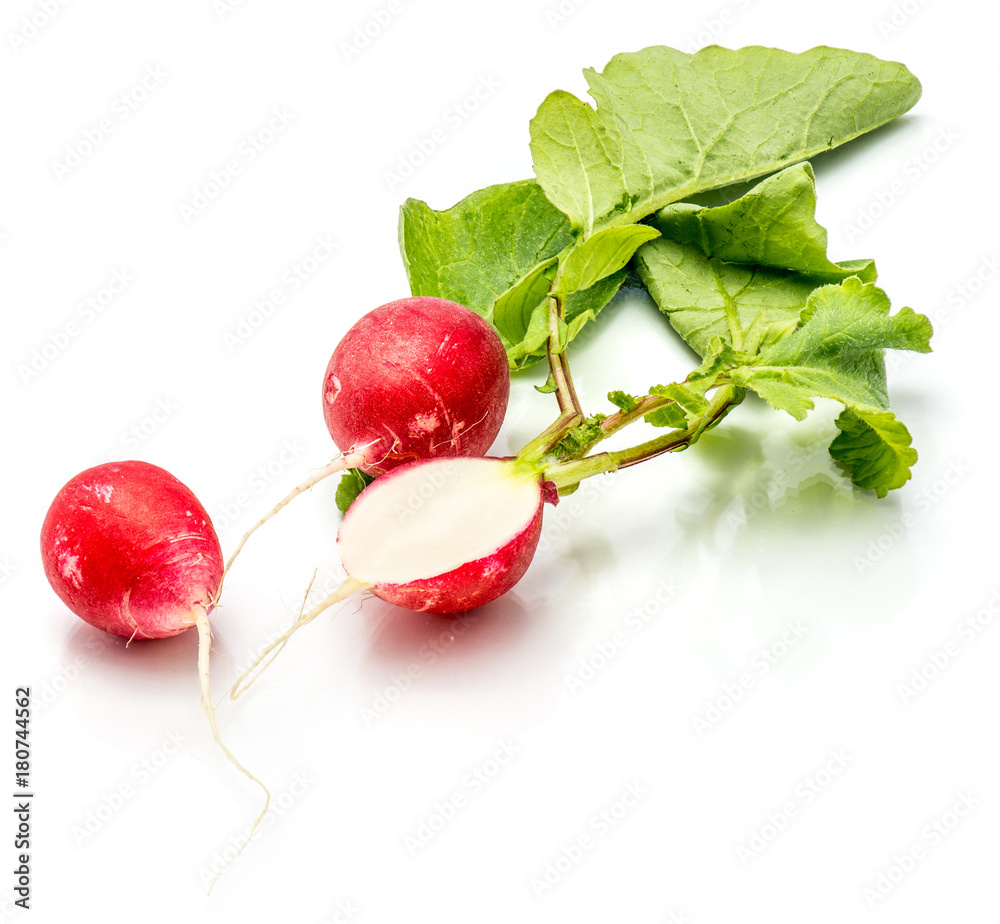 Two whole and sliced red radish, one half, fresh green leaves, isolated ...