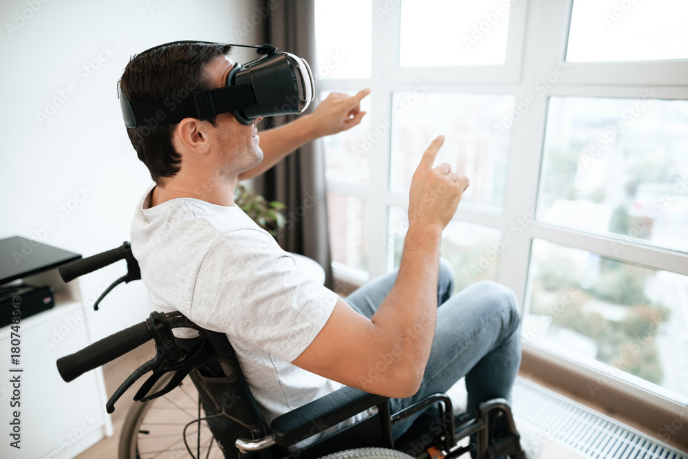 The disabled person is sitting in a wheelchair in virtual reality ...