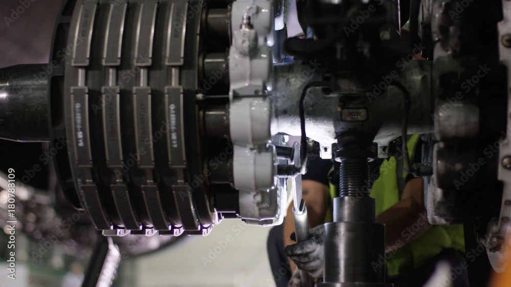 Calm workers controlling aircraft machine and chassis. Aircraft ...