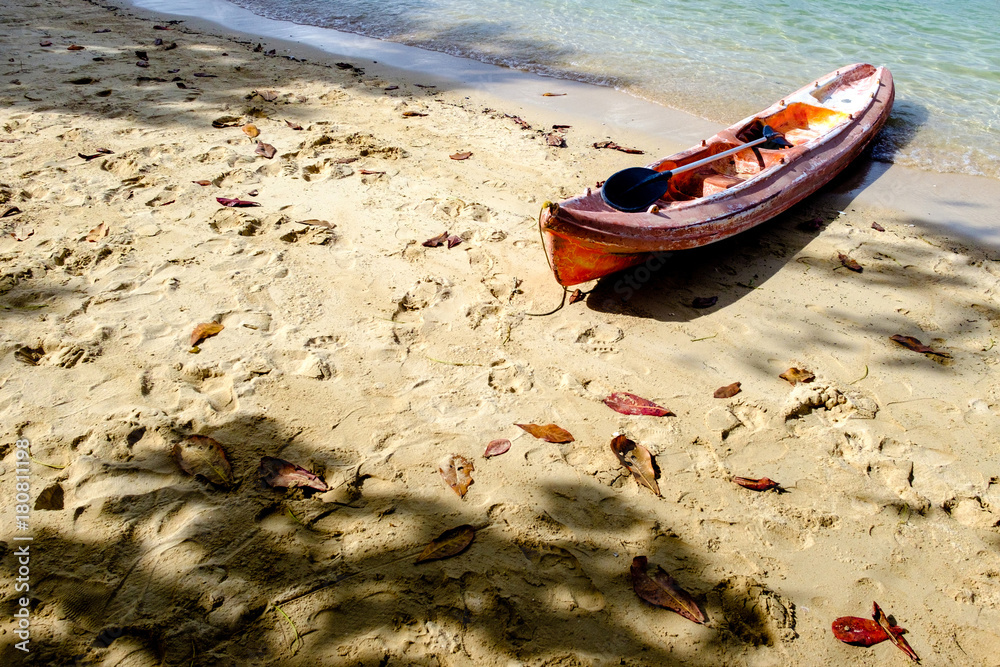 an empty old kayak sits on the beach under the sun Stock Photo | Adobe ...