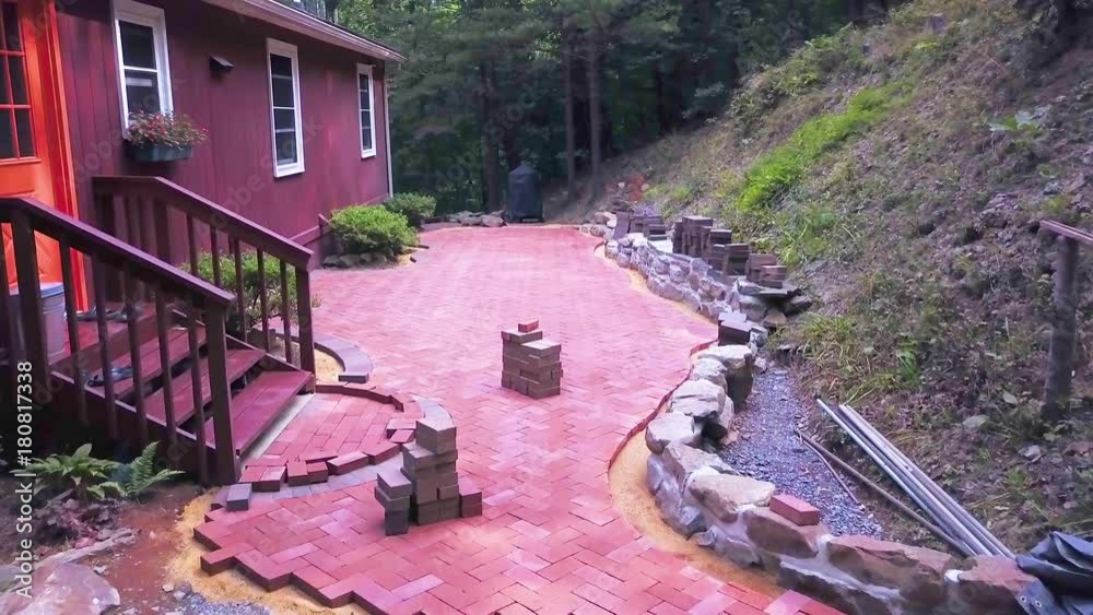 Video „Aerial camera moves over a brick paver project to show the full ...
