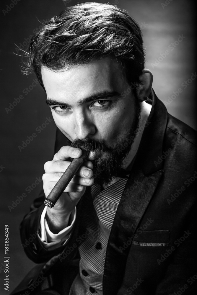 black and white portrait of bearded smoking cigar gentleman in a suit ...