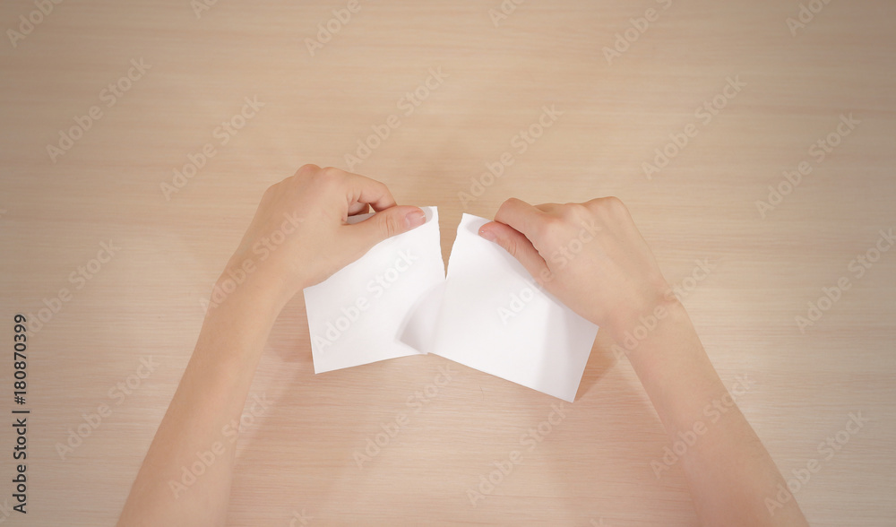 Hands tearing a piece of paper in half blank white flyer brochure ...