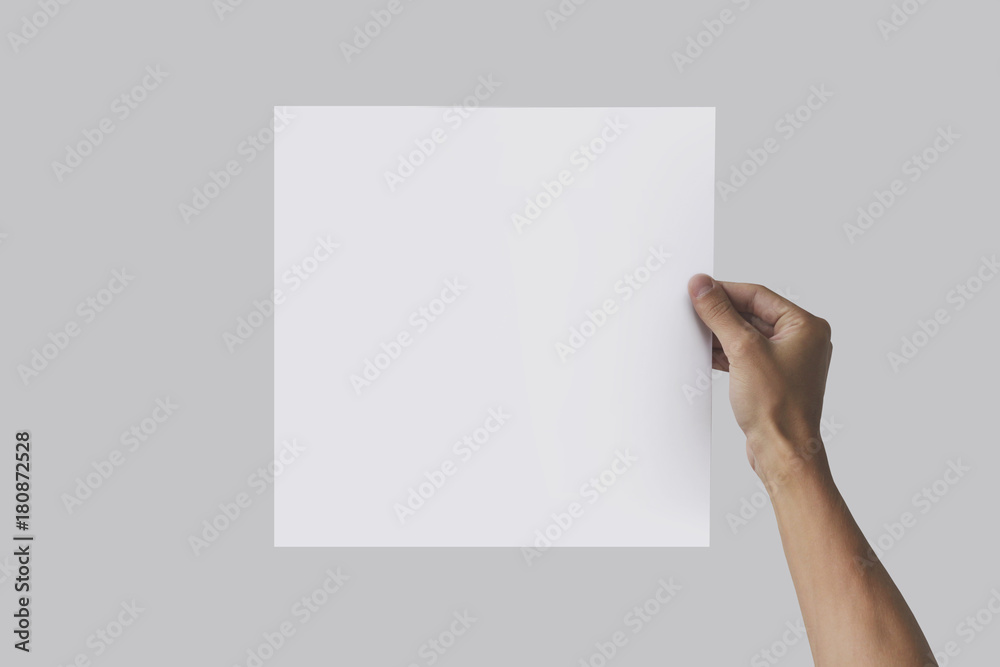 Right hand holding square paper in the right hand. Leaflet presentation ...