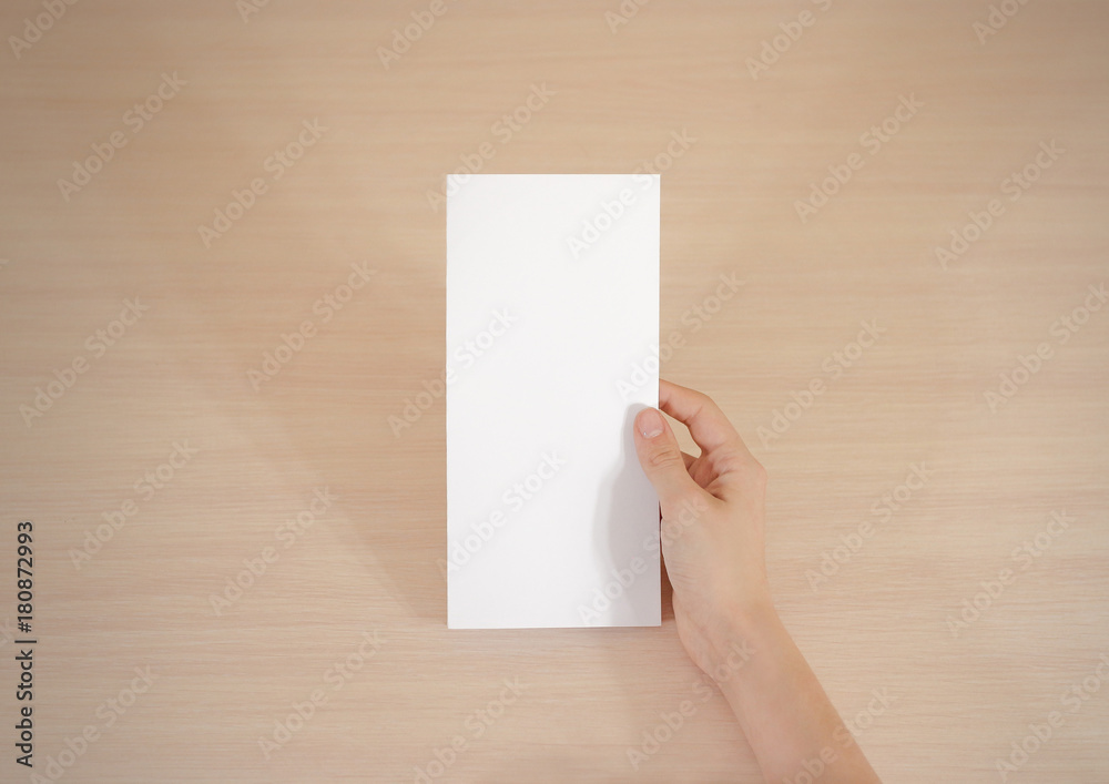 Hands holding blank white brochure booklet in the hand. Leaflet ...