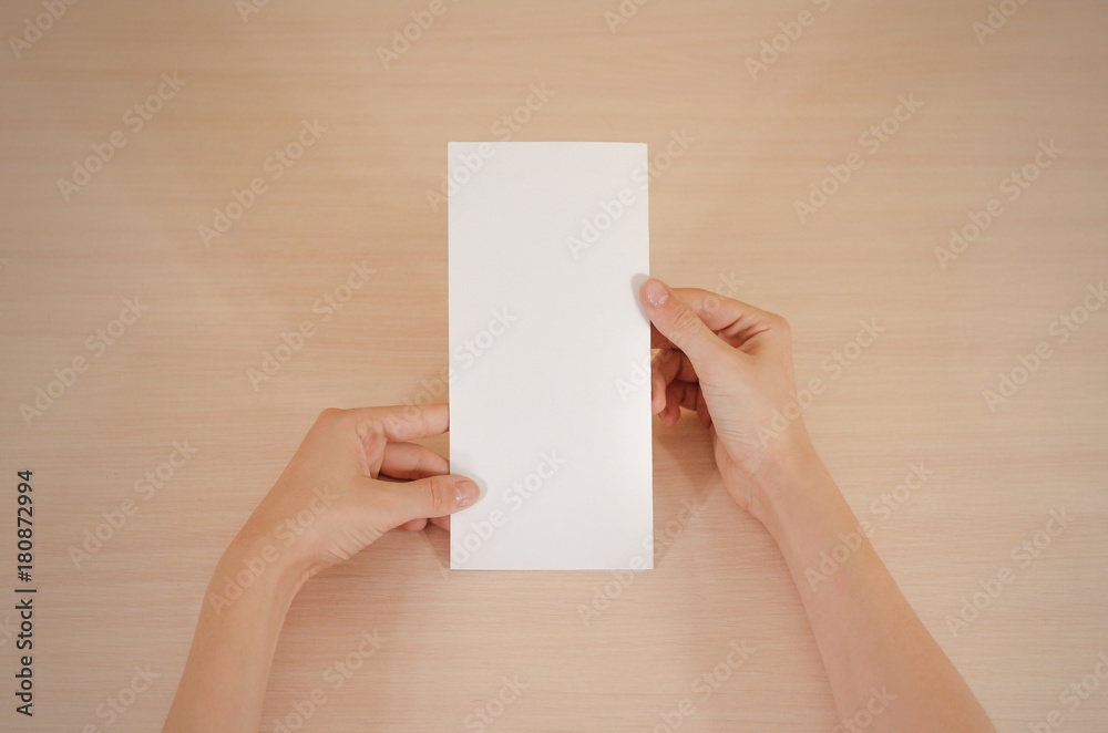 Hands holding blank white brochure booklet in the hand. Leaflet ...
