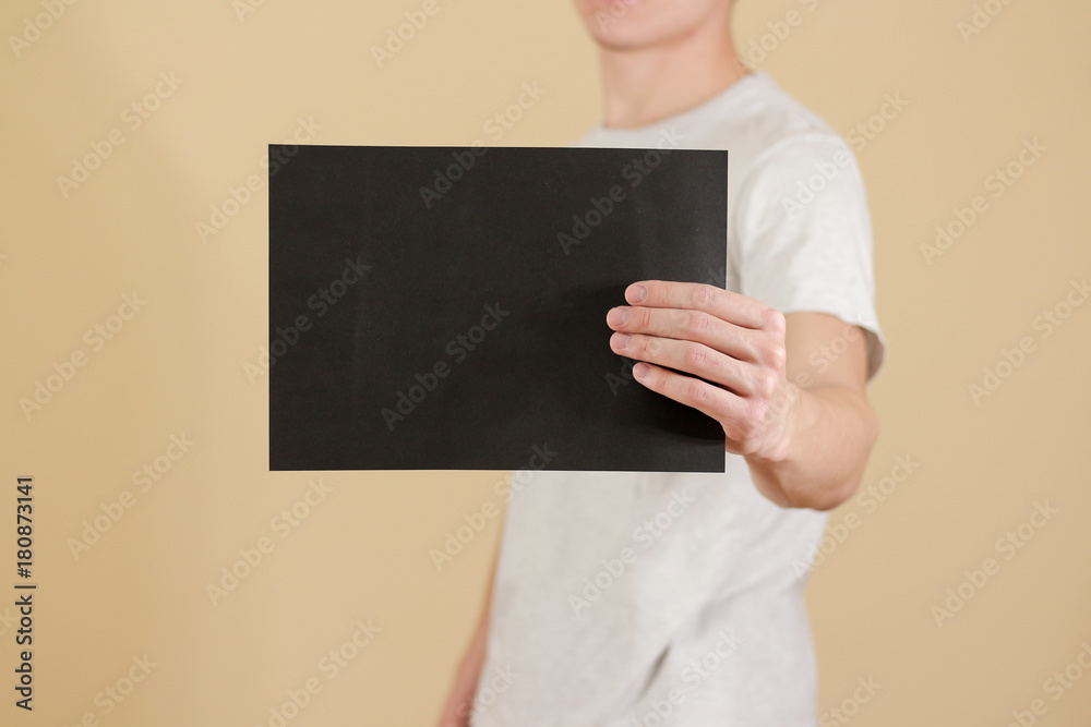 Man holding black A4 paper horizontally. Leaflet presentation. Pamphlet ...
