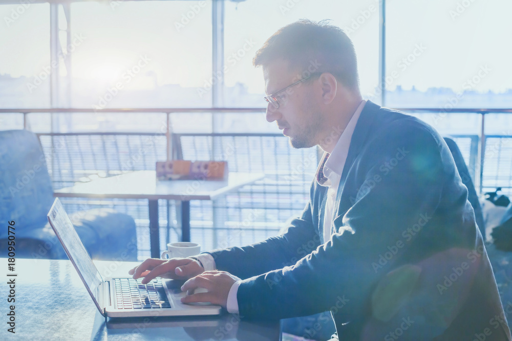 businessman working on computer in modern interior of airport cafe, man ...