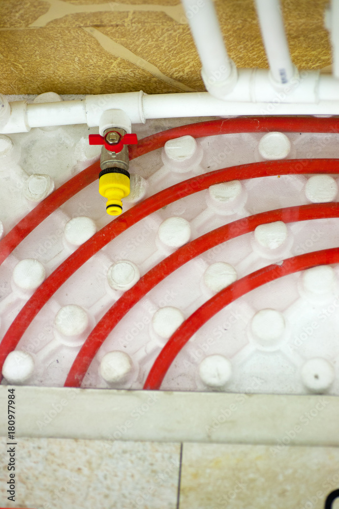 laying of pipes of a warm floor under a laminate of a parquet and a ...