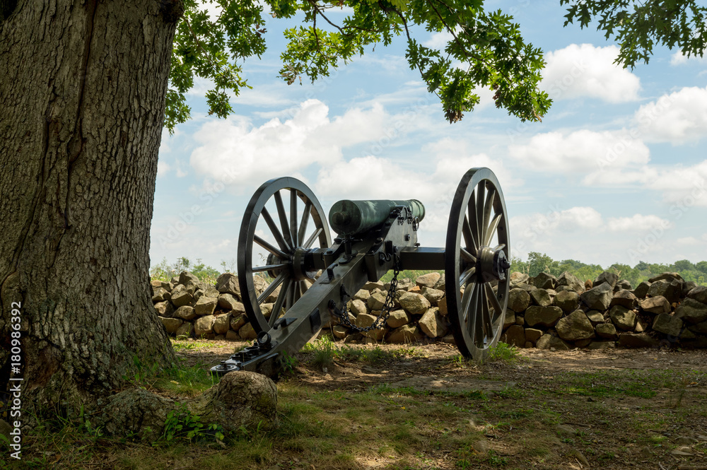 Foto de Historic Cannon Artillery Pointing over Stone Wall do Stock ...