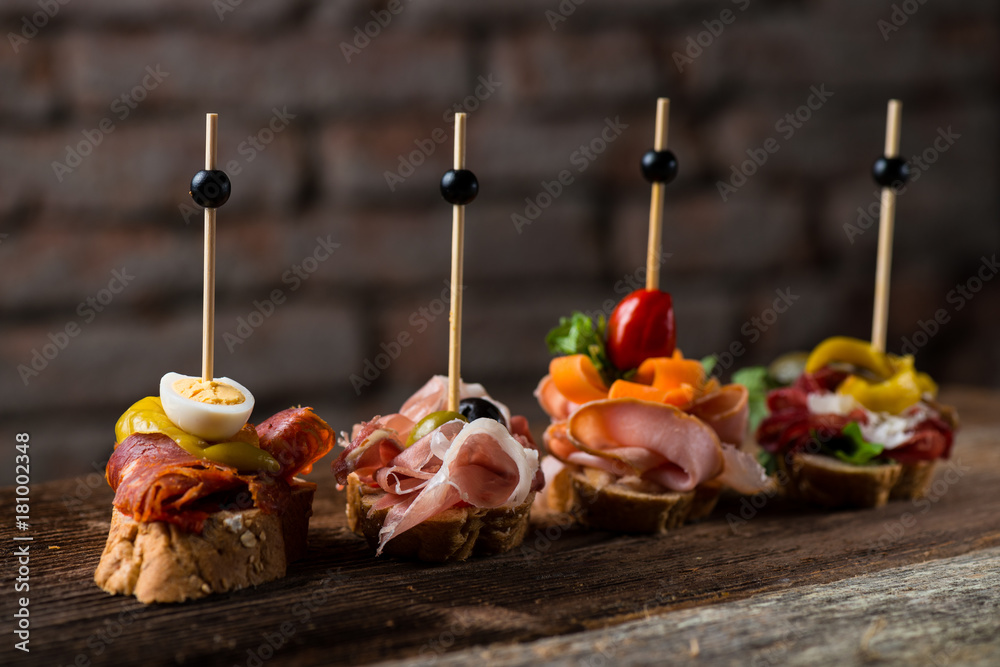 Tapas on Crusty Bread - Selection of Spanish tapas served on a sliced ...