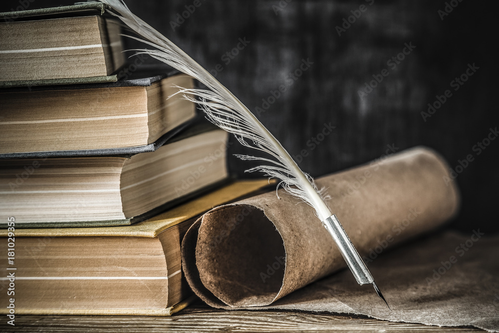 Old quill pen with old paper scroll and books on the table. Letter ...