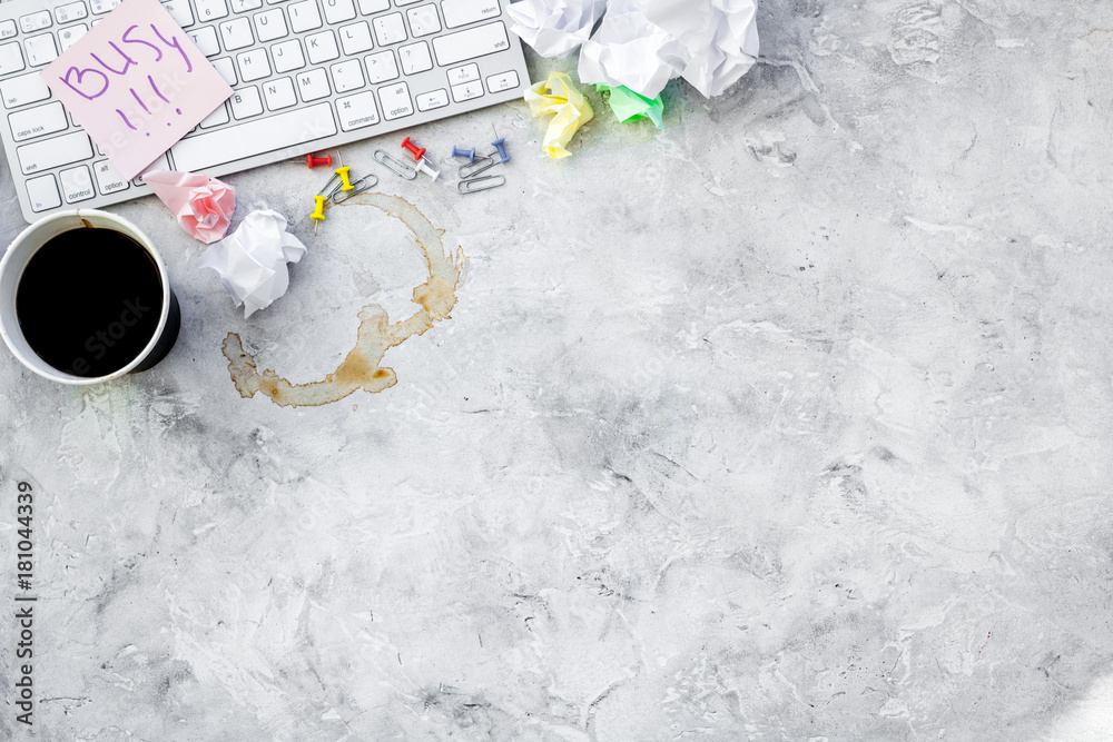 Clutter in office. Desk covered with crumpled paper and coffee stains ...