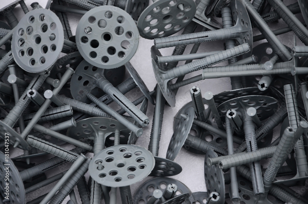 Background pattern of many gray plastic dowels (fastening) for thermal ...