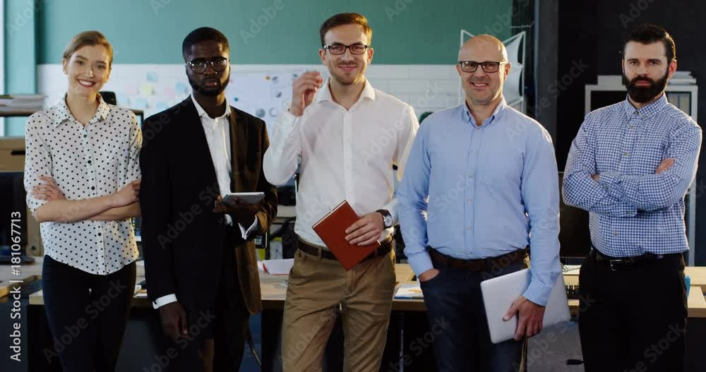 Portrait of mixed races office team posing in the modern office space ...