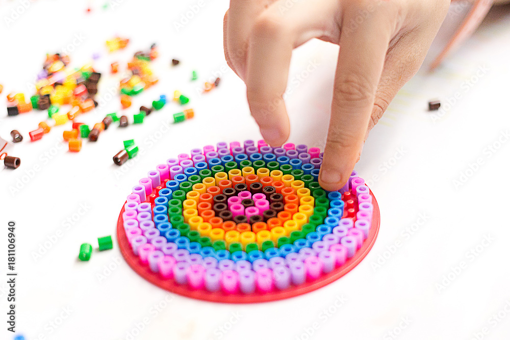 Soft focus Hand little girl with pyssla Stock Photo | Adobe Stock