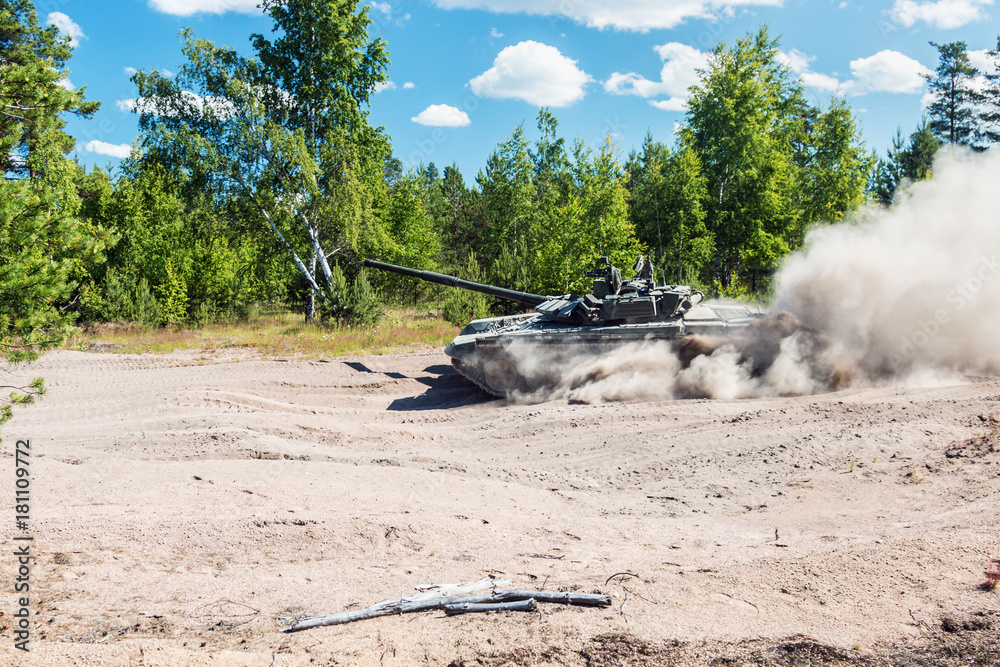 Main battle tank are going to dust on the ground through the forest for ...