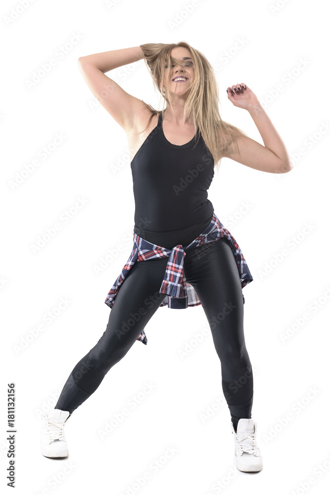 Smiling relaxed woman dancer with hand in hair moving and dancing ...