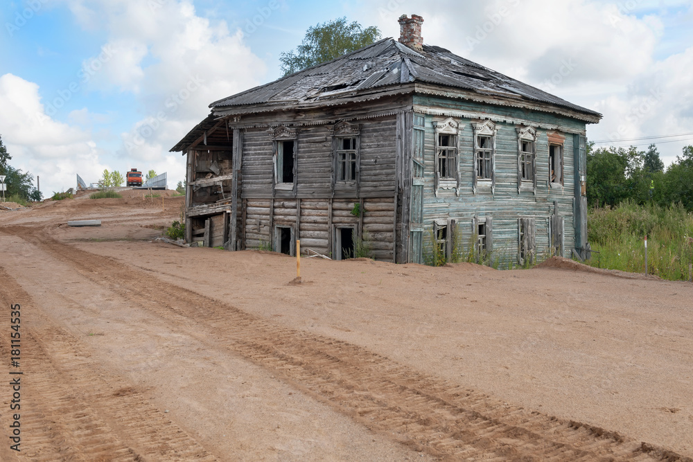 Old decaying evicted two-storey house at the construction site of the ...