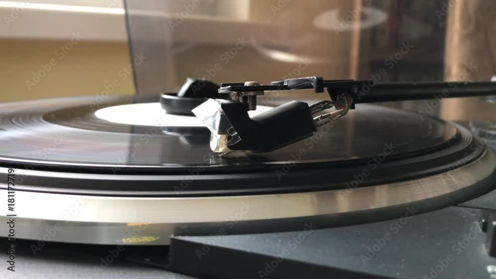 Close-up of using an antiquarian vinyl record player. Man relaxing ...