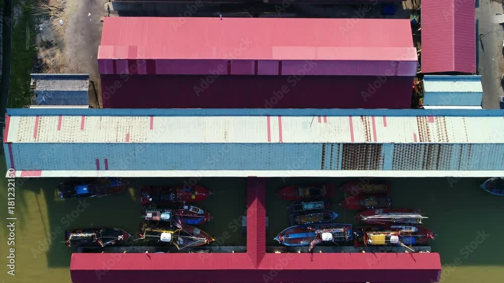 An aerial view of fishing boat docking to load and offloading fishes ...