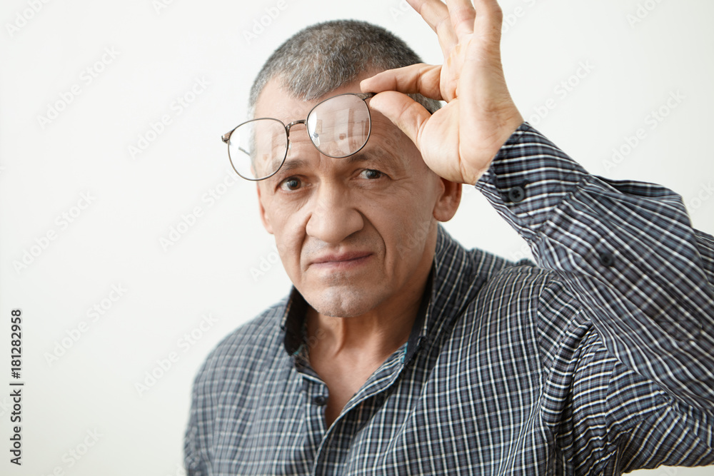 Head and shoulders of handsome long sighted senior man of Caucasian ...