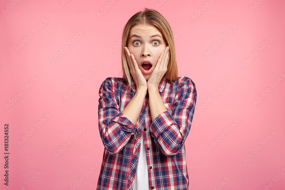 Shocked surprised female model being scared by someone, looks horrified ...