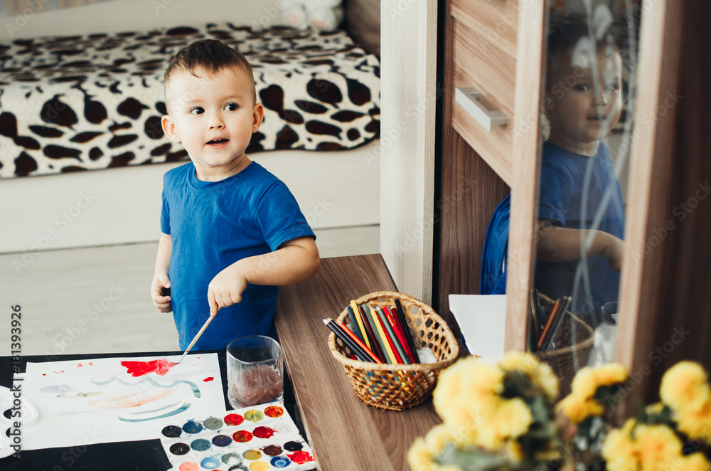 the baby in the nursery, with enthusiasm draws paints Stock Photo ...