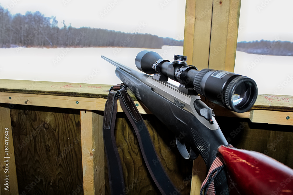 Side view of a rifle in a hunting blind Stock Photo | Adobe Stock