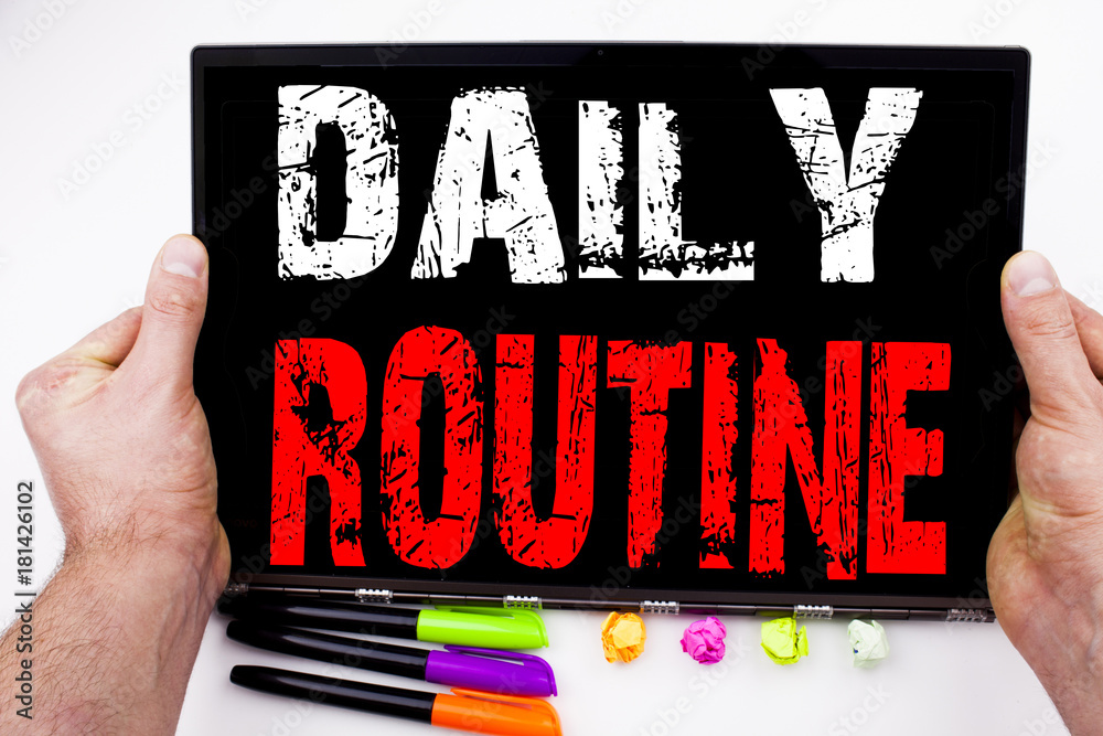 Daily Routine text written on tablet, computer in the office with ...