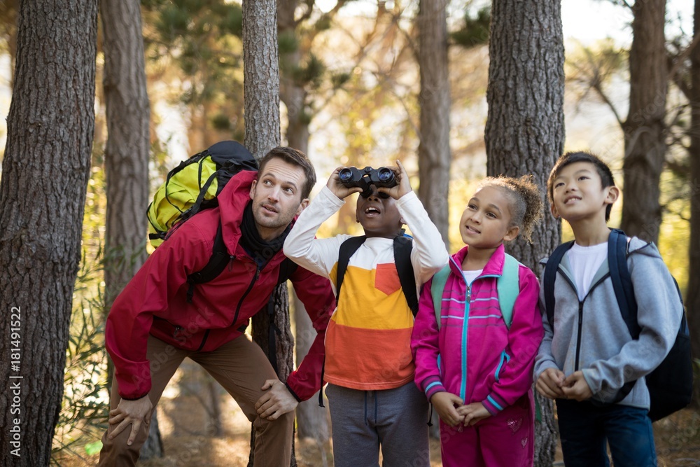 Teacher and kids exploring in park Stock Photo | Adobe Stock