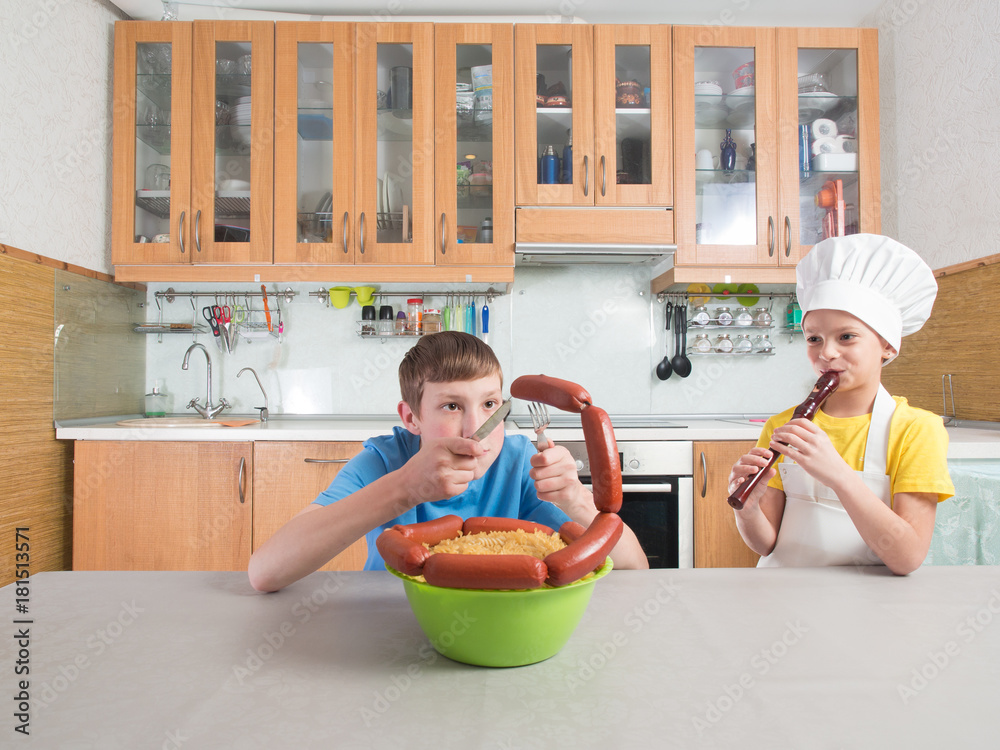 Little girl in the form of a chef with an apron and a cap smiles and ...
