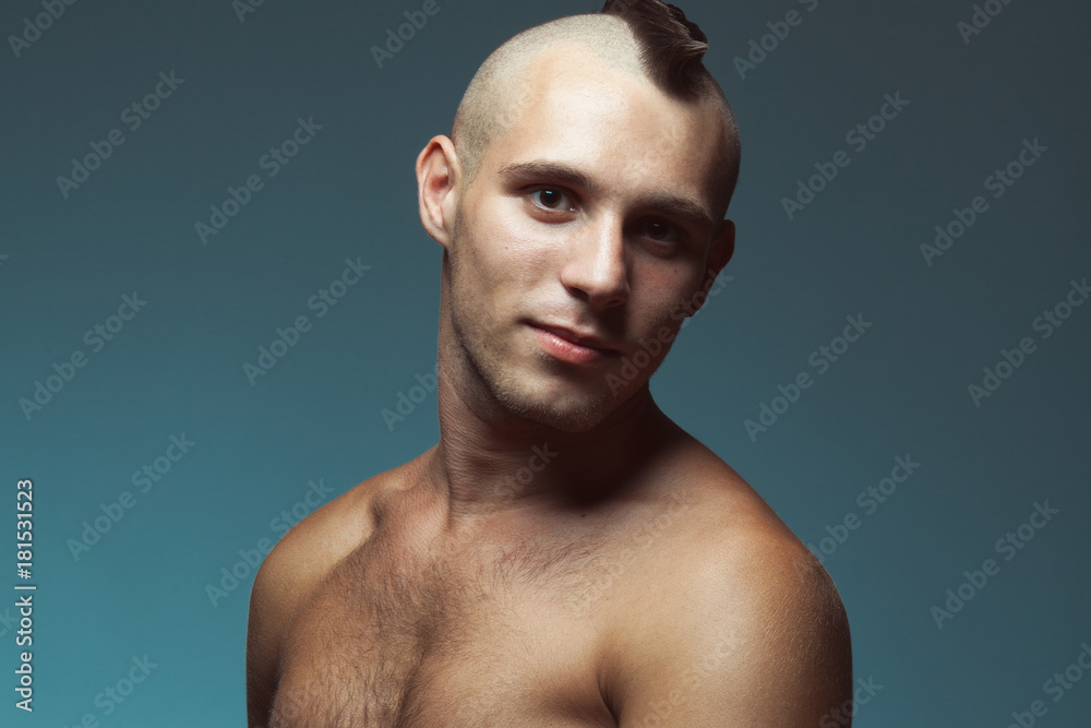 Male beauty concept. Handsome muscular male model posing over blue ...