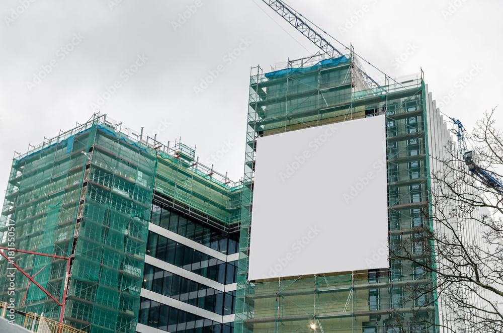 Blank white street banner on construction of office building being ...