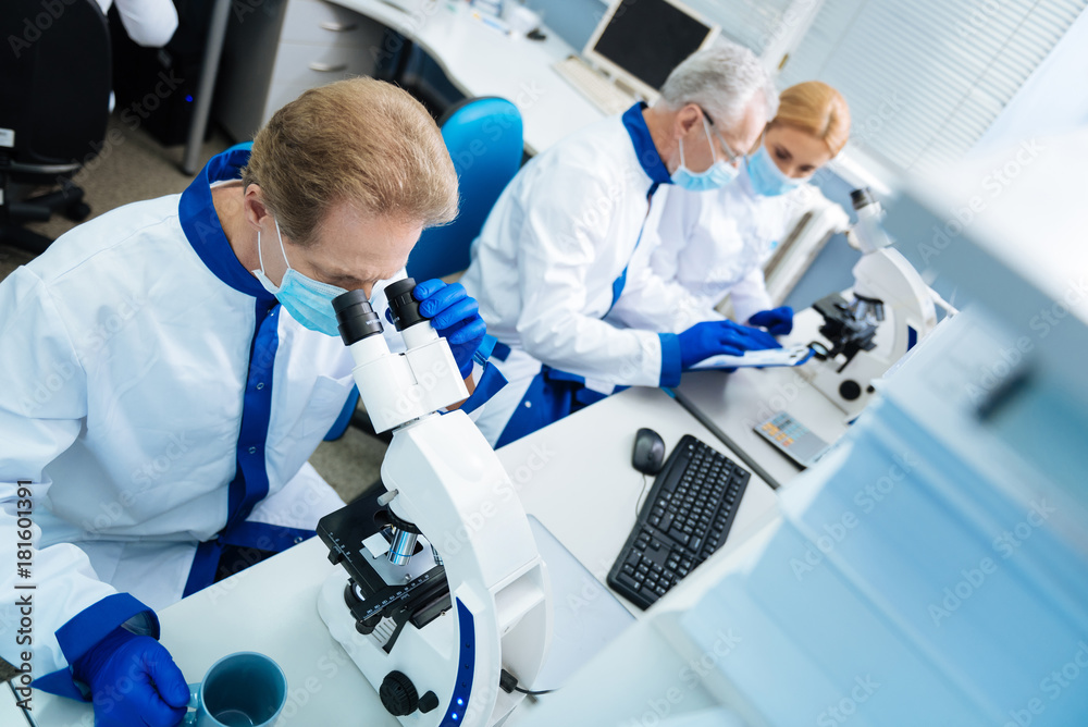 Investigating chromosomes. Serious concentrated researcher of middle ...