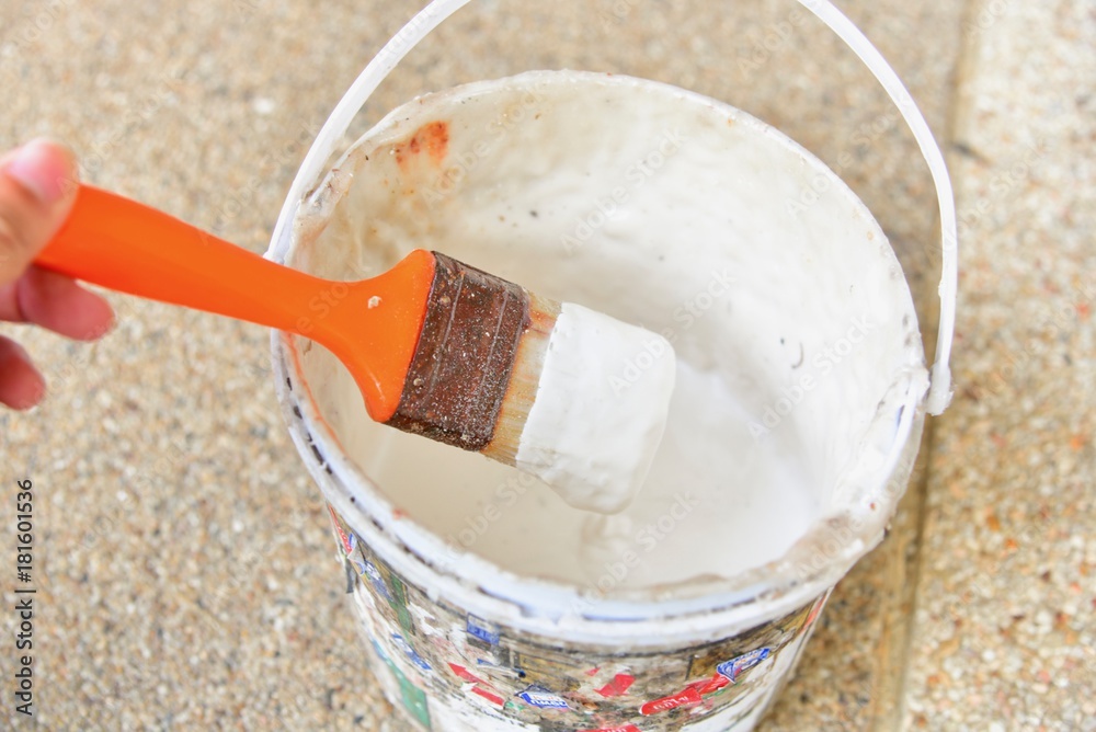 Hand Dipping a Paint Brush into Wallpaper Paste or Wallpaper Adhesive ...