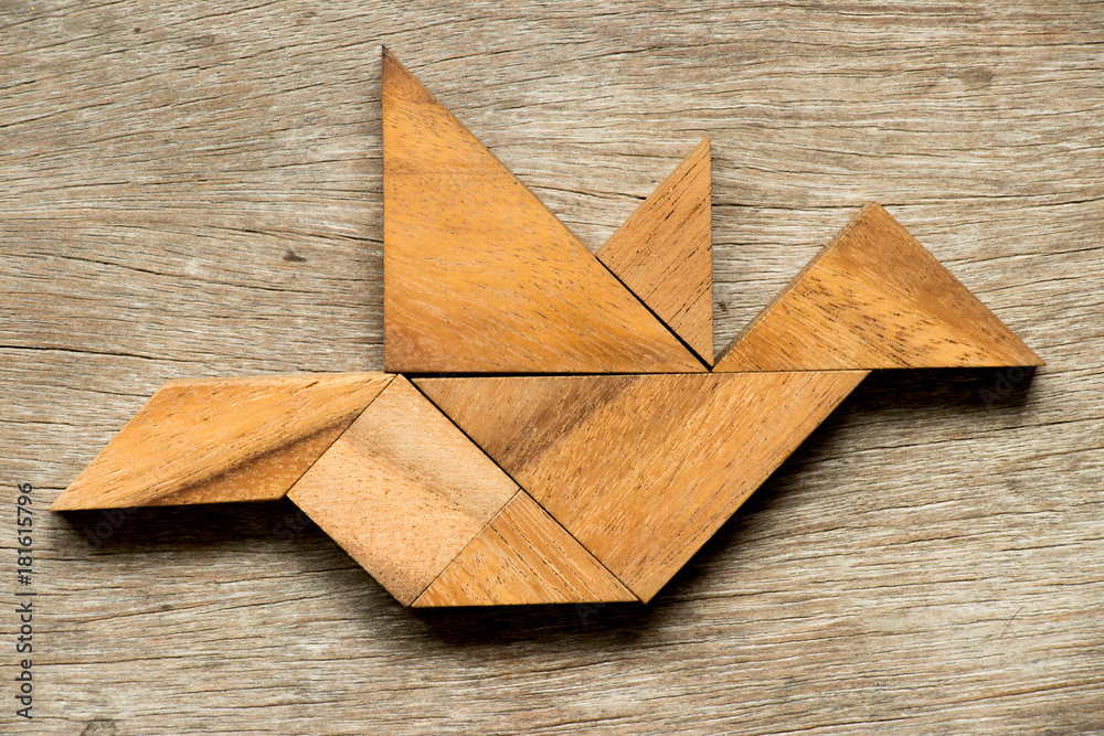 Wood tangram puzzle in flying bird shape background Stock Photo | Adobe ...