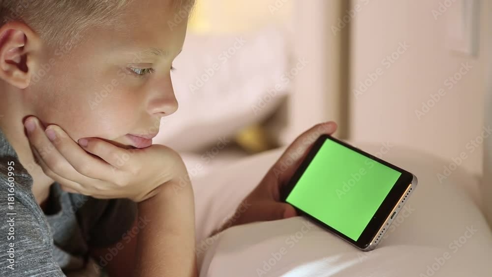 Mockup video of cute calm blond kid laying in bed in home interior ...