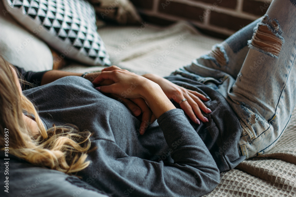 Beautiful woman lying on the bed. Cropped image with beautiful hands ...