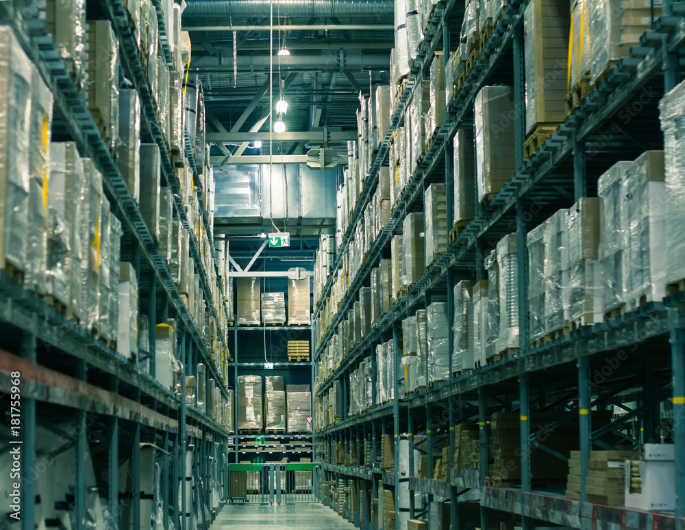 Rows of shelves with boxes in modern large-scale warehouse, pallet ...