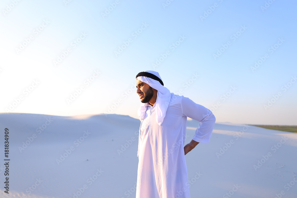 Handsome Arab sheik suffers from discomfort in back, standing in Stock ...