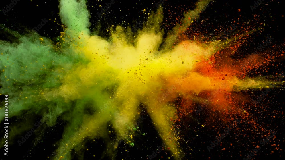 Colorful powder/particles fly after being exploded against black ...