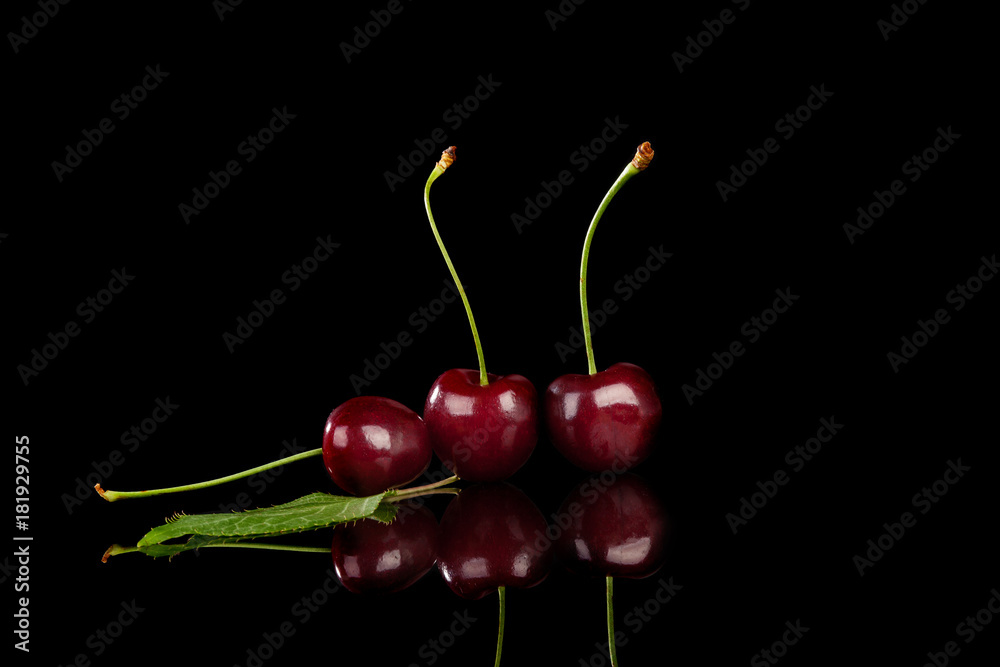 Red cherries on black background Stock Photo | Adobe Stock