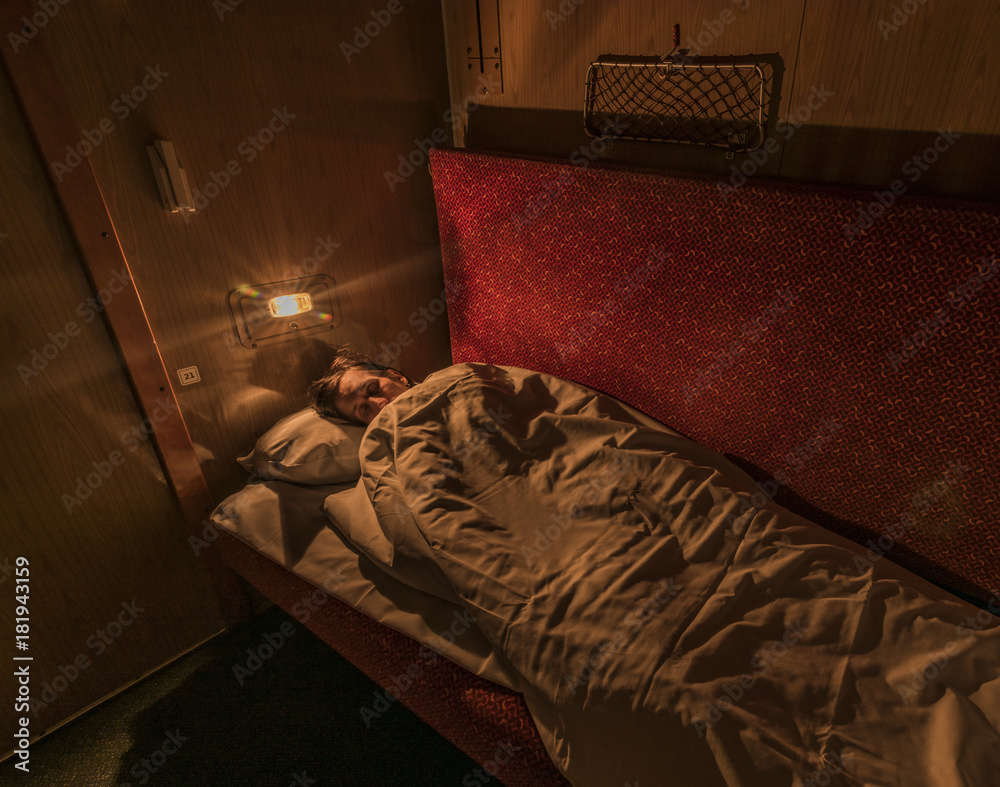 Man sleeping in night train with beds and wash basin Stock Photo ...